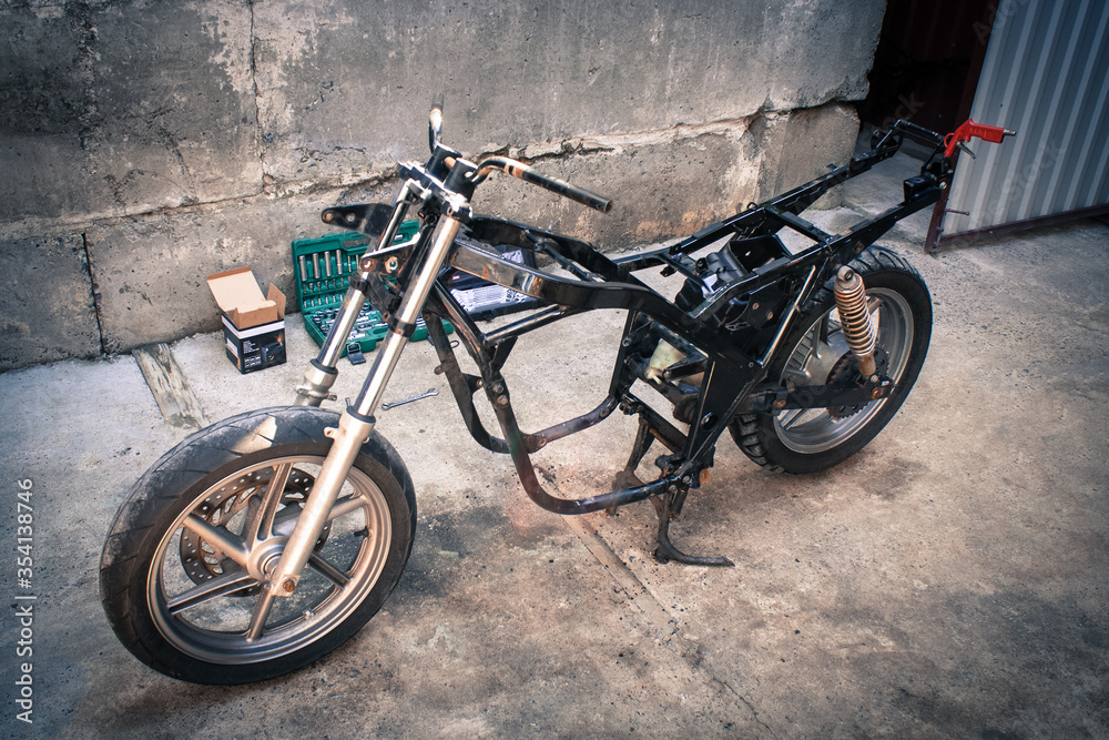 Disassembled motorcycle, without skin, tank and motor. The frame of the ...