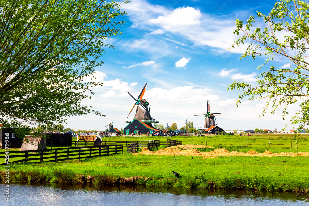 Dutch typical landscape. Traditional old dutch windmills with blue ...