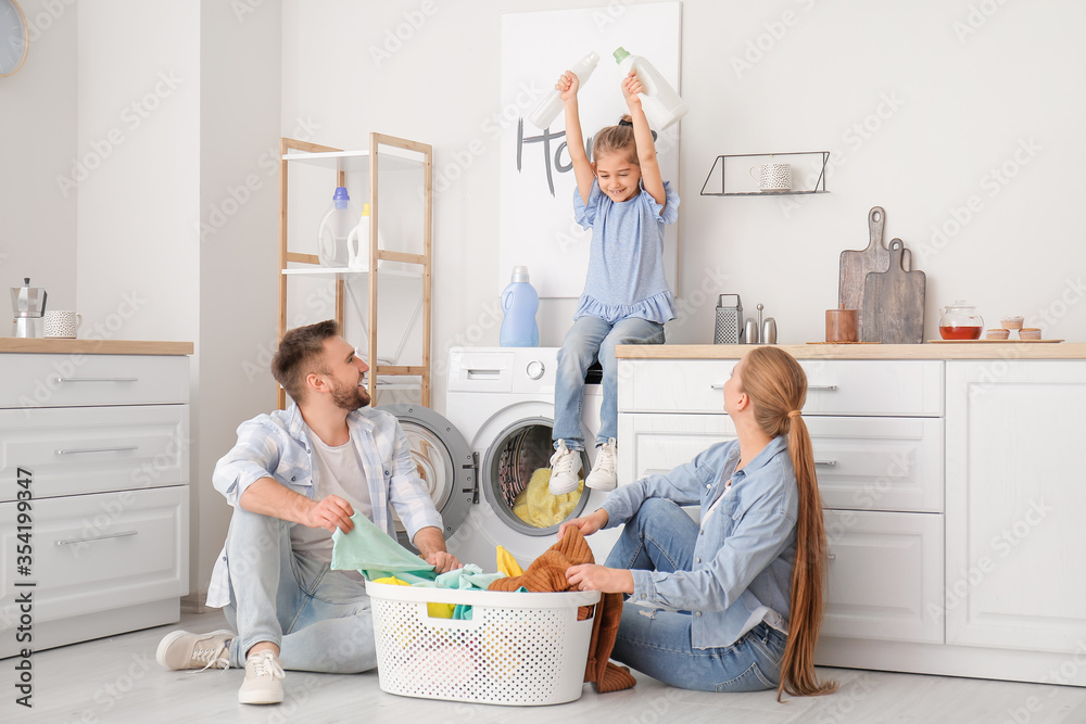 Happy family doing laundry at home Stock Photo | Adobe Stock