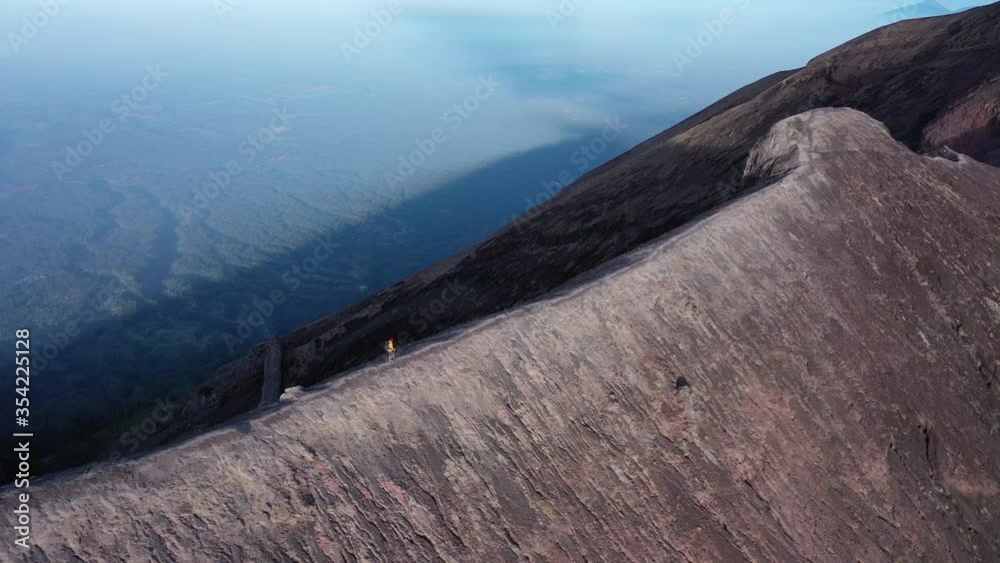 Volcano trekking at sunrise. Circular Flight from the drone. climbing a ...