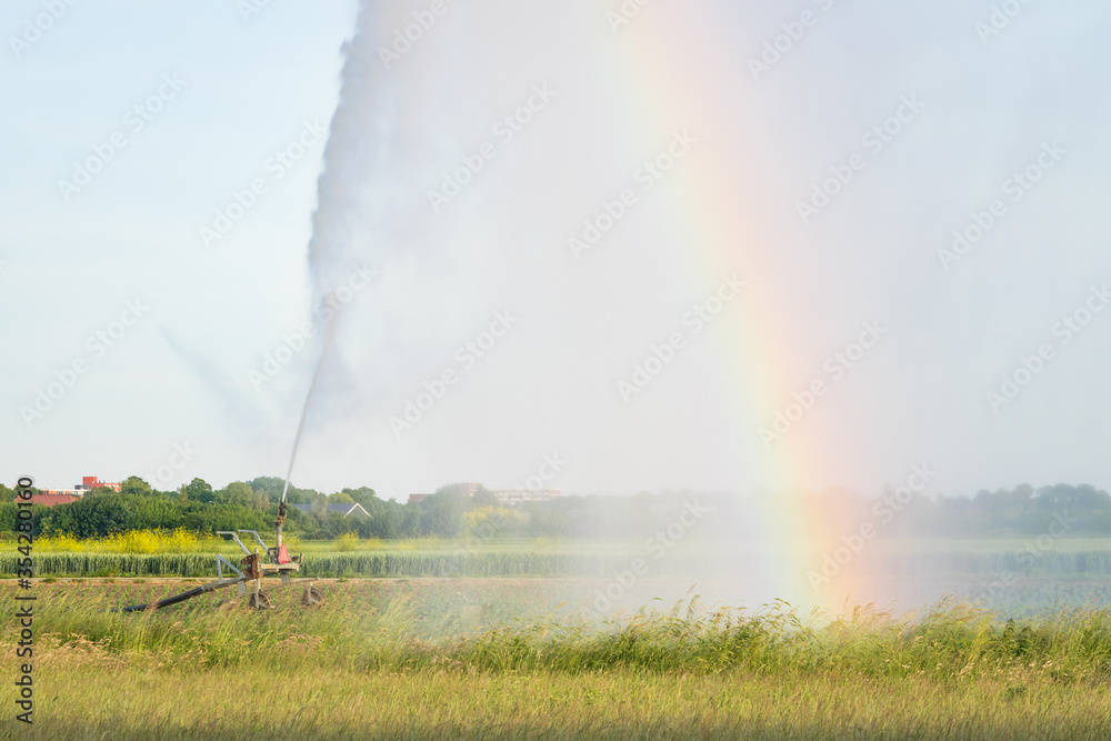 Rainbow caused by the refraction of light in water droplets from an ...