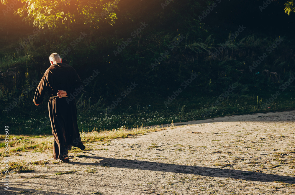 monk of the Capuchin Order, an adult wise man with a beard and in long ...