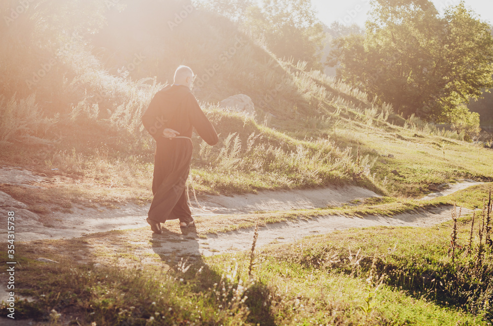 monk of the Capuchin Order, an adult wise man with a beard and in long ...