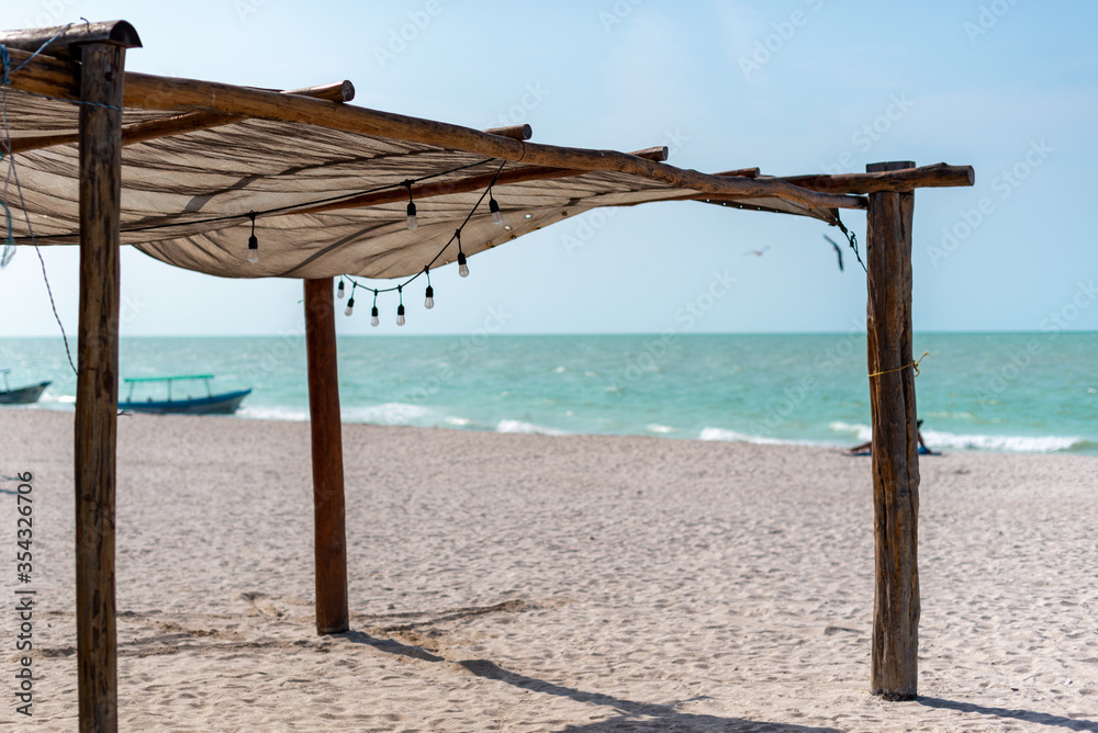 Sun protection roof on a mexican sandy beach to enjoy the hot sun (in ...