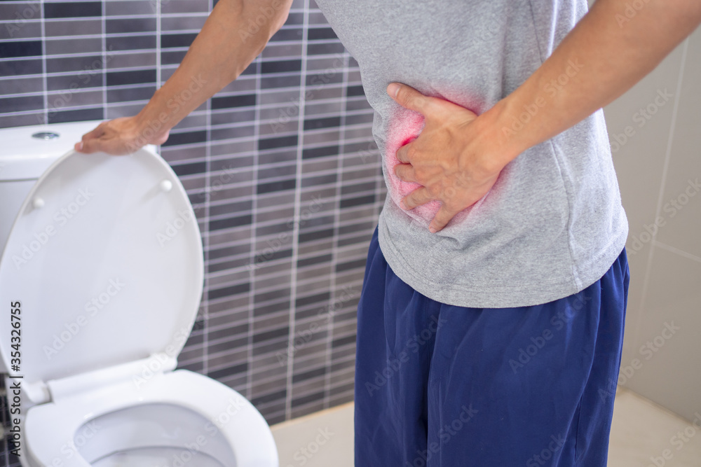 Men are standing with their bellies in front of the toilet in the ...