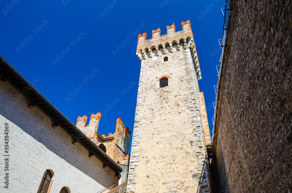 Tower and stone walls with merlons of Scaligero Castle Castello di ...