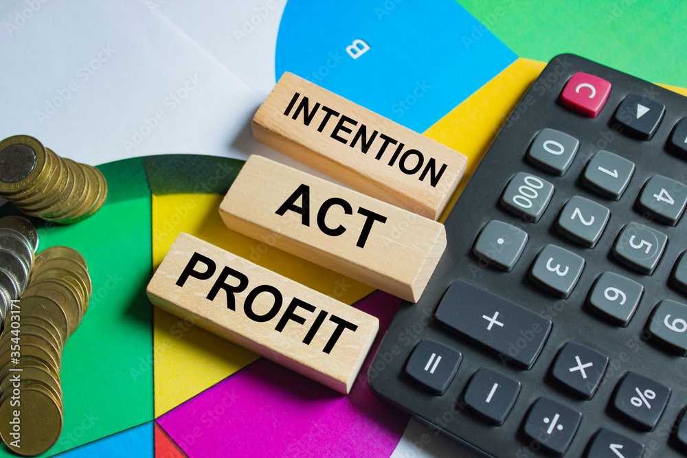 The inscription intention, act and profit on wooden blocks on the ...