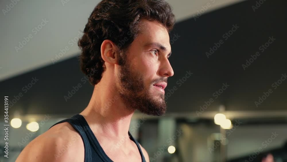 Close-up of face of athletic bearded young man with muscular wiry body ...