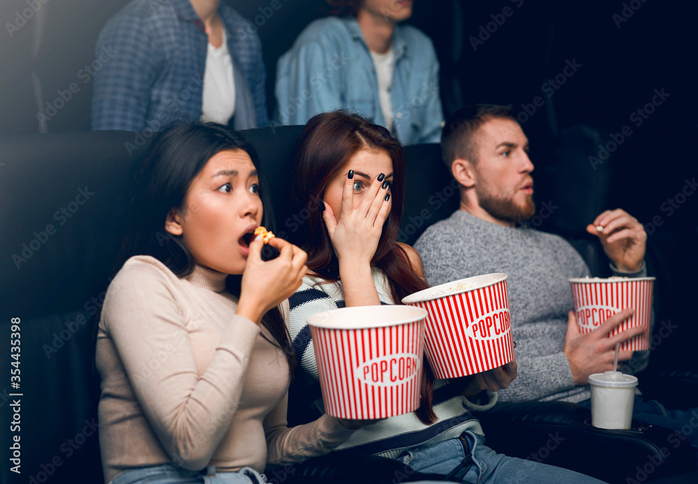 Young people scared of horror movie in film theater Stock Photo | Adobe ...