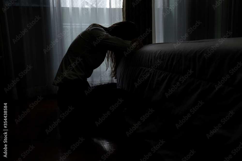 Sad young woman sitting on the bed in the bedroom, People with ...