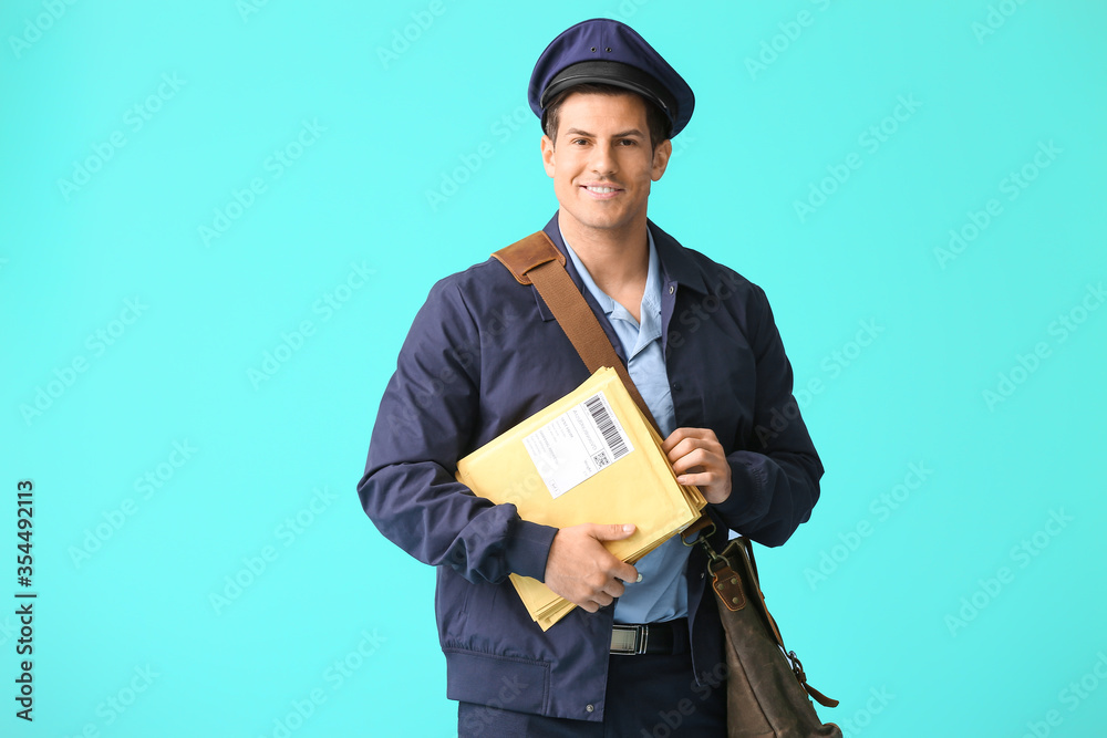 Handsome young postman on color background Stock Photo | Adobe Stock