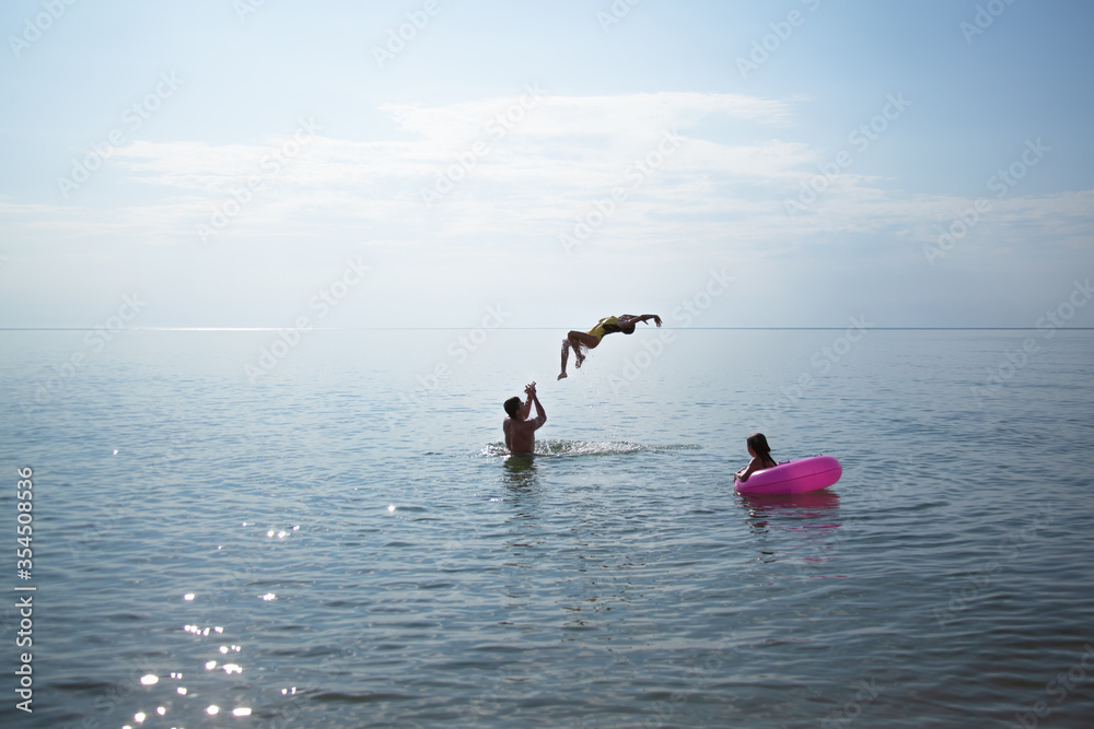 Father take fun with his daughters. The kids do acrobat element in ...