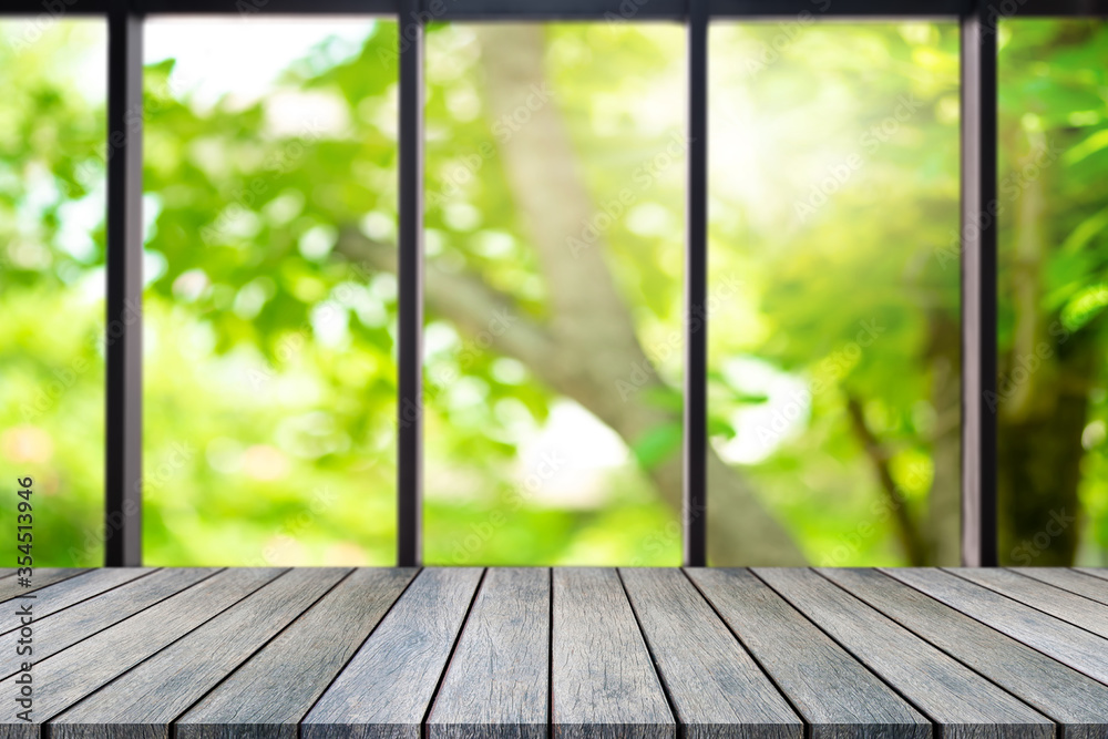 Perspective wooden board empty table on top over blurred natural ...