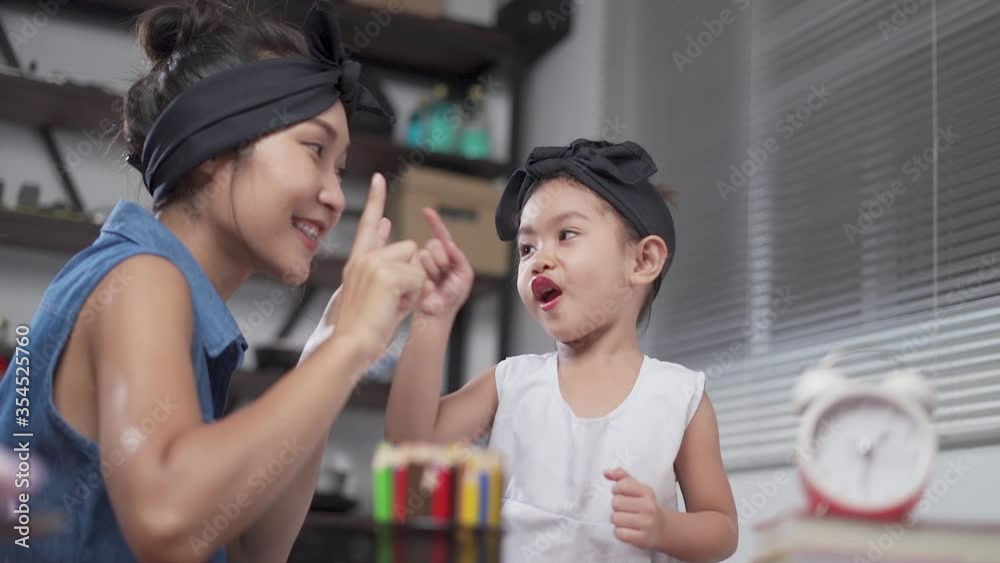 Mother is teaching daughter to count numbers in the house. Stock Video ...