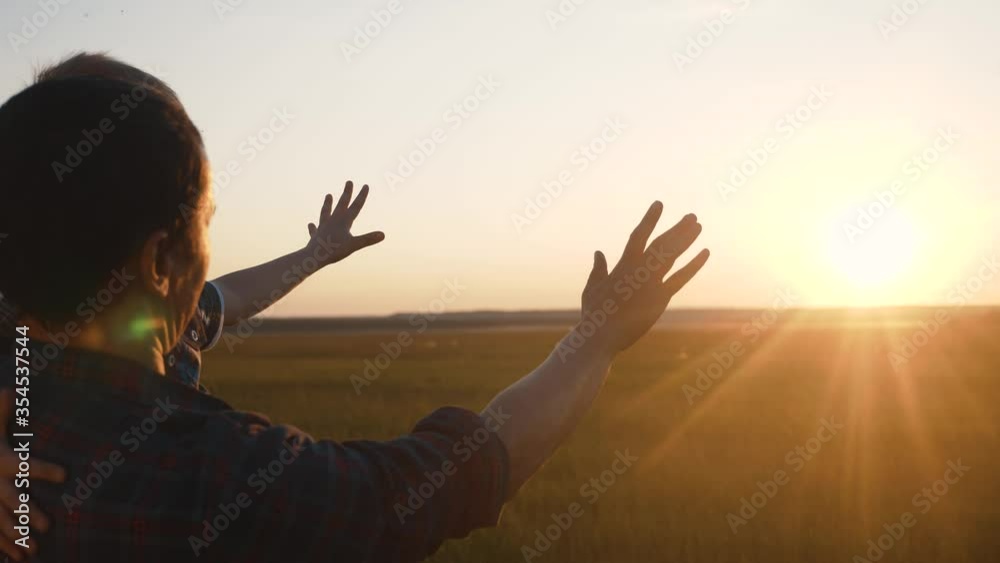 happy family father and son are pulling teamwork hands to the sun. dad ...