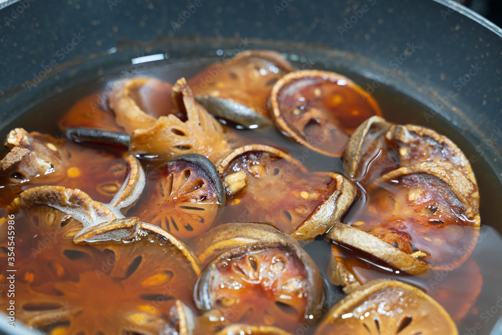 cooking boiled Quince fruit ( Aegle marmelos, Bael fruit or wood golden ...