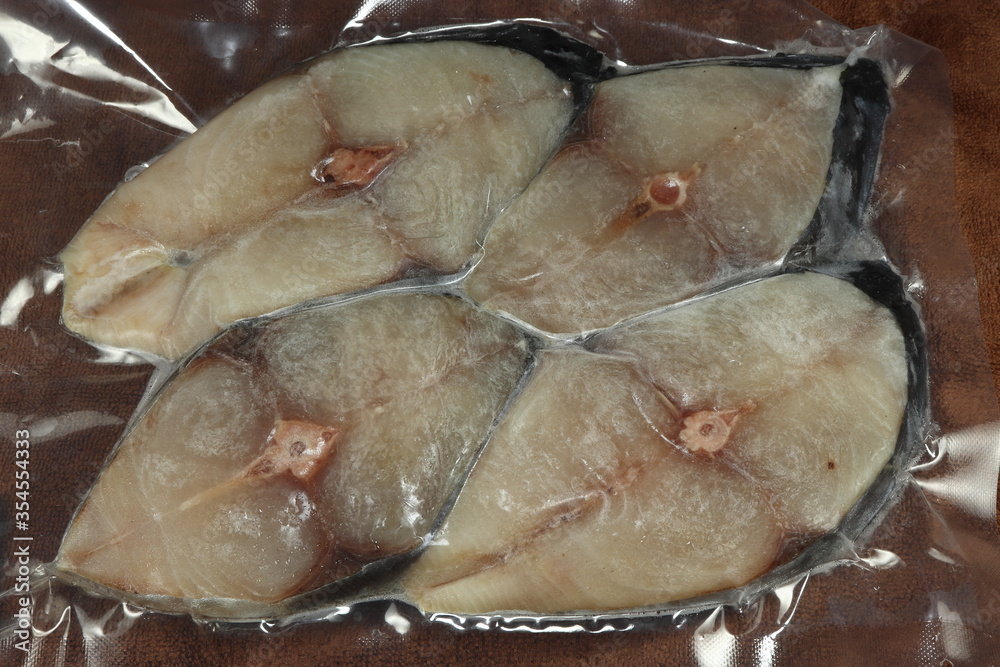 Cutting Dried King mackerel fish in the plastic bag. Packaging sealed ...