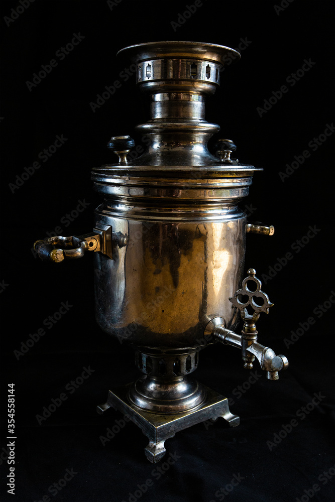 an old samovar isolated on a black background.Russian samovar.Metal ...