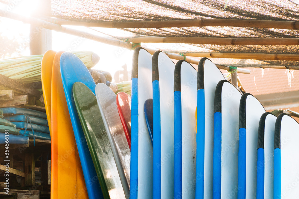 Set of different color surf boards in a stack by ocean.Bali.Indonesia ...
