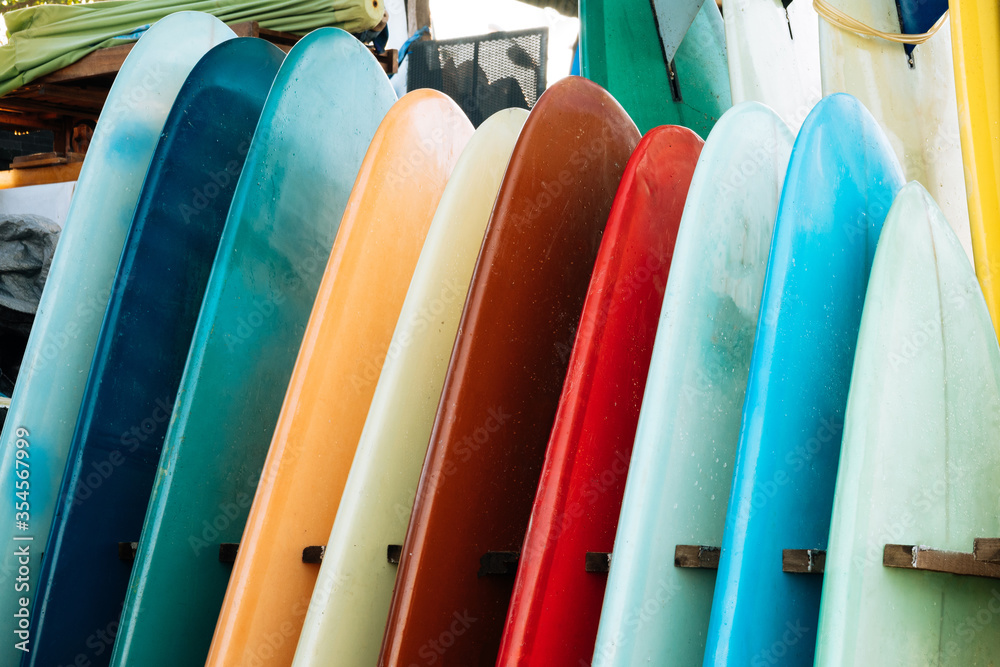 Foto de Set of colorful surfboard for rent on the beach. Multicolored ...