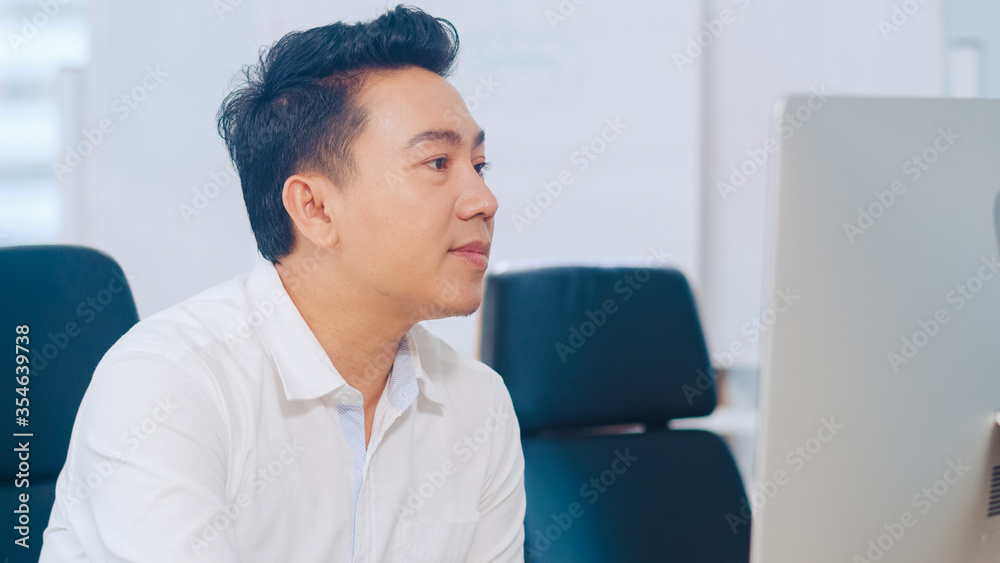 Successful executive Asian young businessman smart casual wear using ...