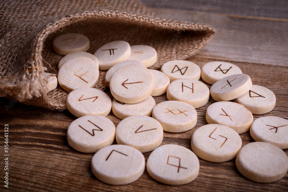 Wooden runes on a wood background. Ancient alphabet known as the ...