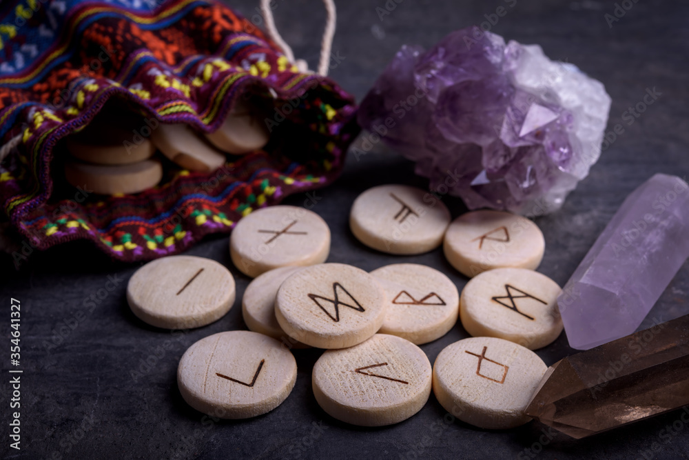 Wooden runes on a black background. Ancient alphabet known as the ...