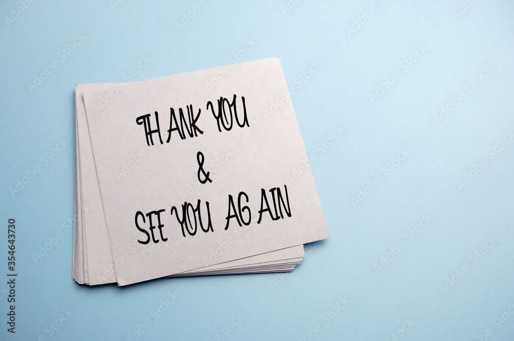 note paper written thank you and see you again over blue background ...