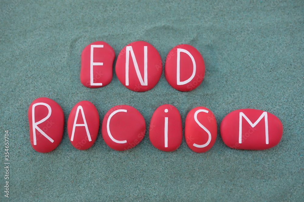 End Racism, social issue text composed with red colored stone letters ...
