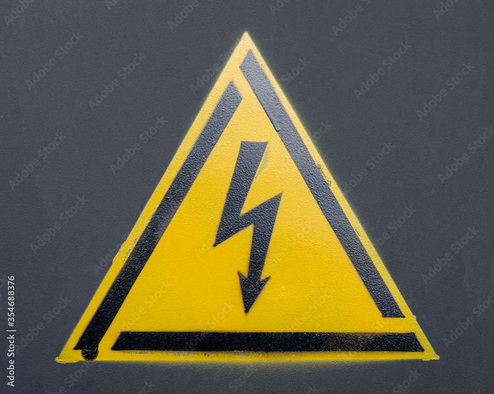 Warning sign against electric shock. The frame is black in the form of ...