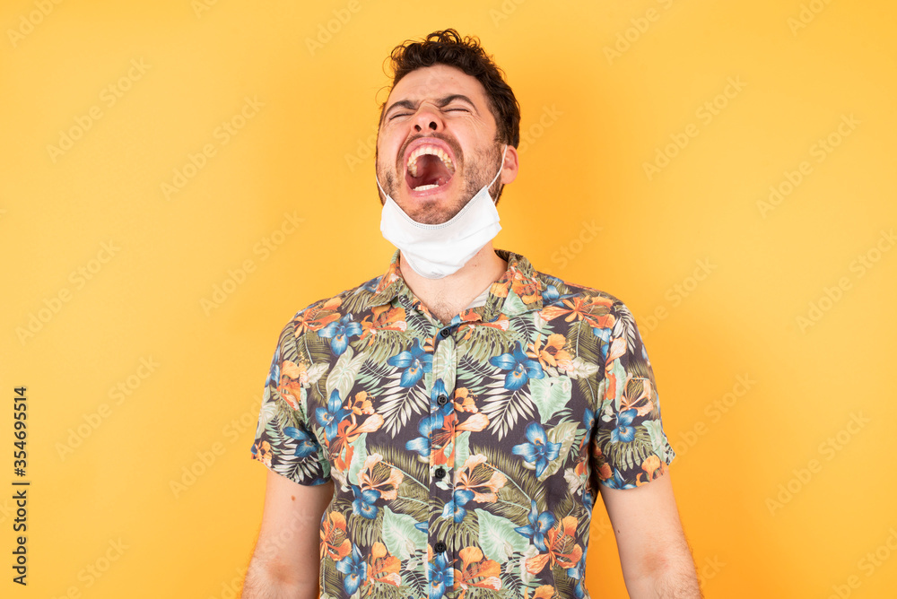 Young beautiful caucasian man with short hair wearing hawaiian shirt ...