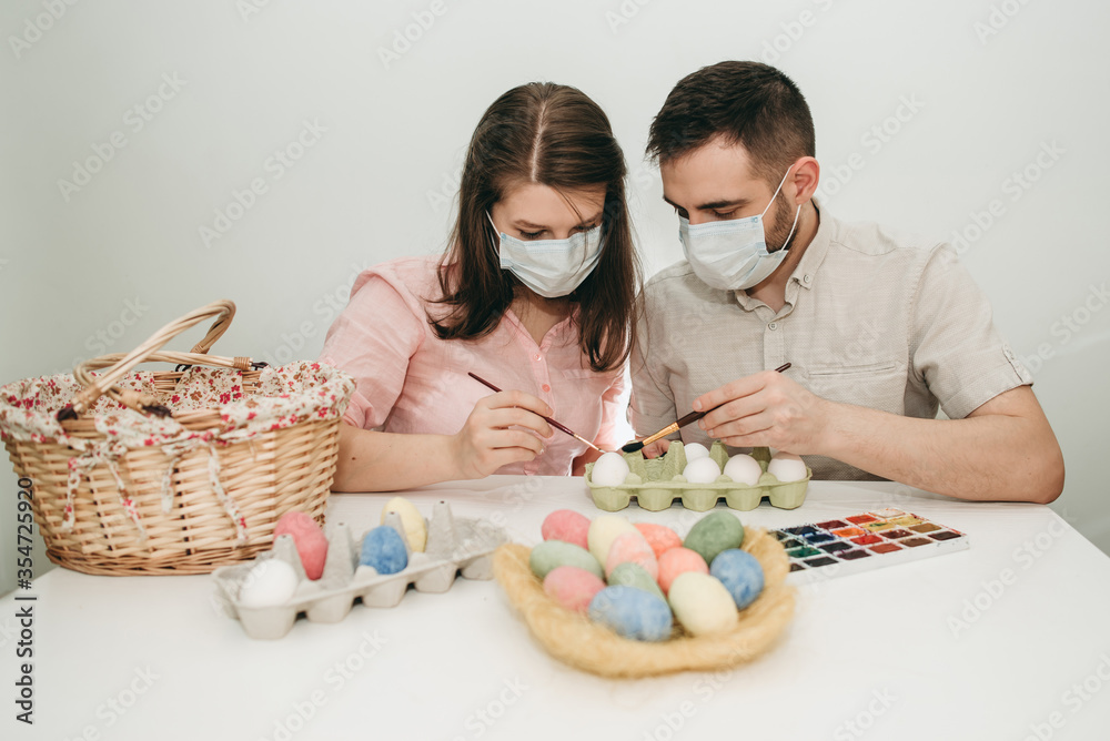 Young white European couple celebrating paint Easter quarantine at home ...