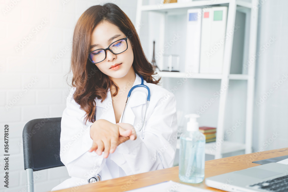 Medical healthcare beautiful Asian doctor using hand sanitizer gel ...