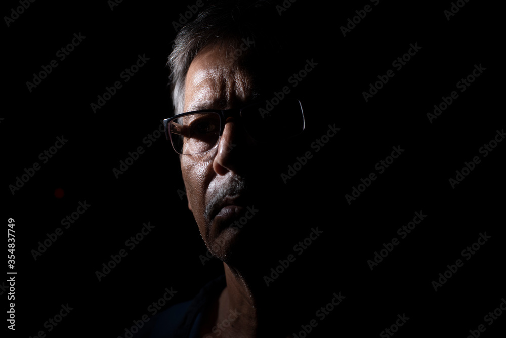 Portrait of a sad Indian Bengali man in light and shadow. Stock Photo ...