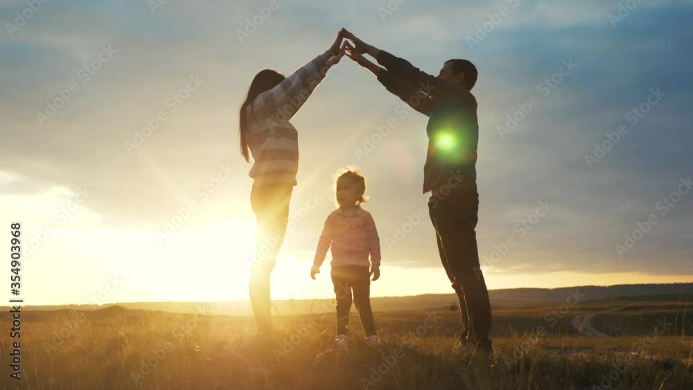 happy family. teamwork adult parents and small children shows a house ...