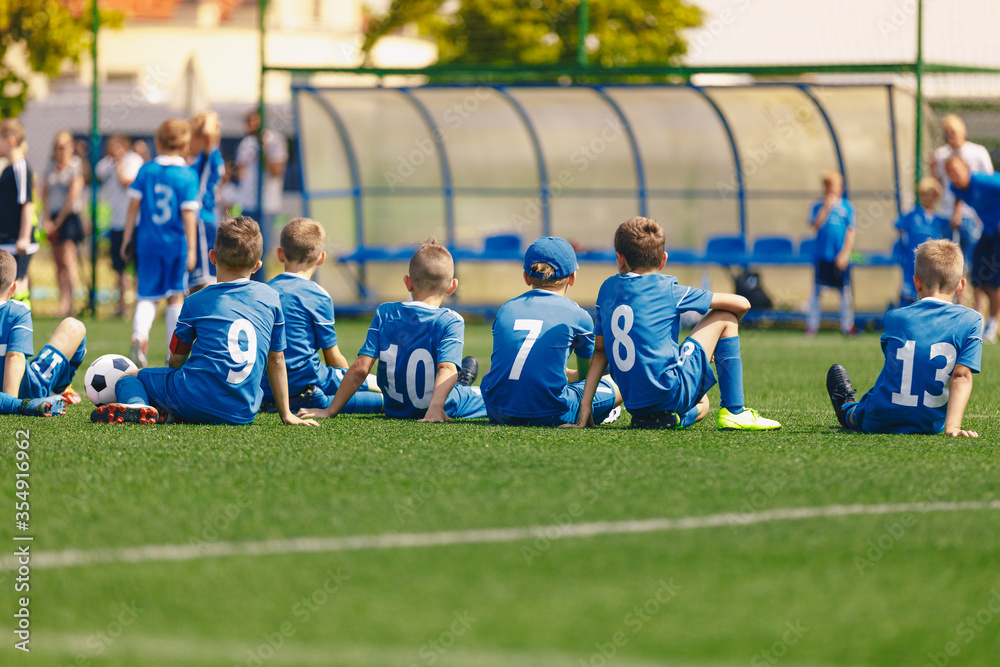 Youth Football Team Members Sitting Together on the Field. Kids Playing ...