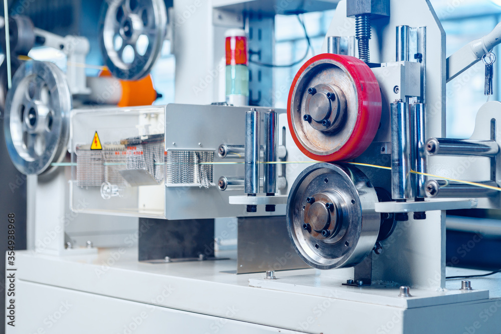 Inside a modern plant producing power electric cables and optical ...