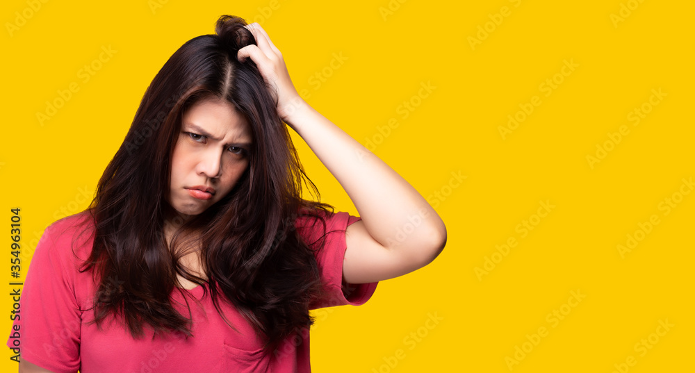 Scowling girl scratching her head who always forget something every ...