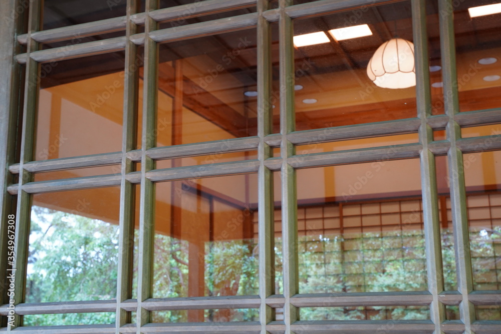 Japanese old wood architecture with big glass window and green garden ...