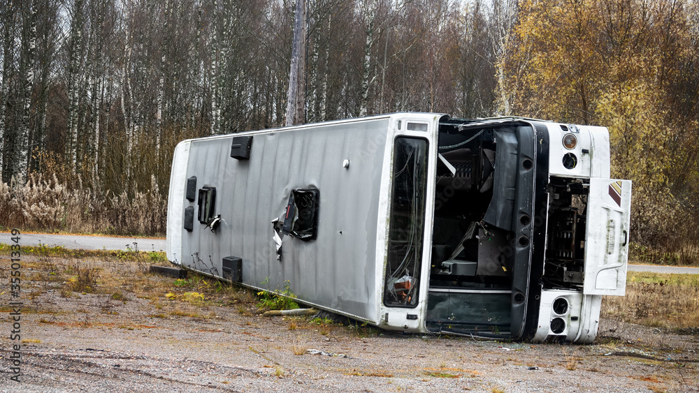 Broken after accident bus on its side. Stock Photo | Adobe Stock