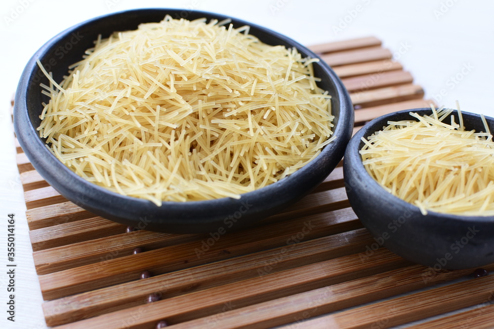 Short pasta spaghetti angel hair displayed in containers on white ...