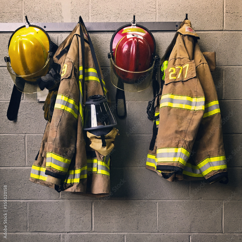 Firefighter helmet and protection coat hanging in the fire station ...