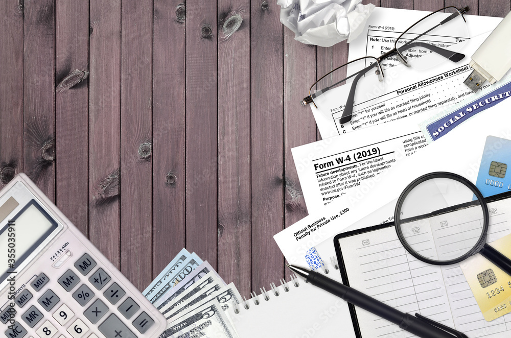 IRS form w-4 Employees Withholding Certificate lies on flat lay office ...