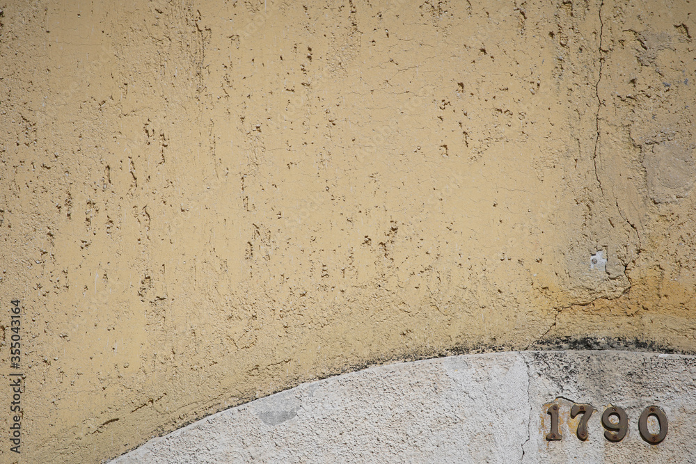 the yellow wall of the temple and the swallowed door. Half of a number ...