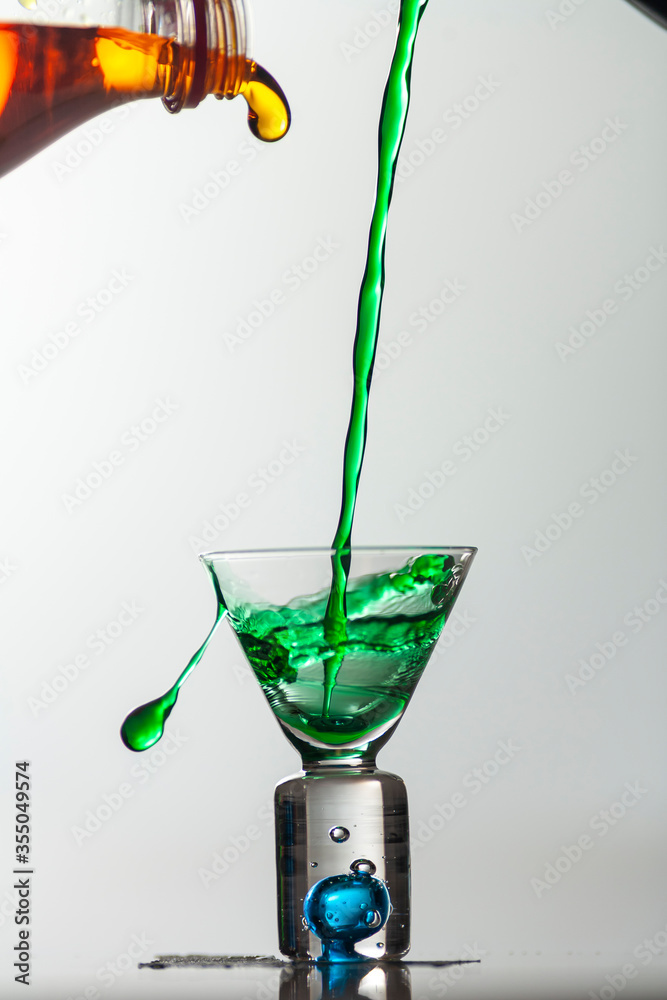 Pouring different color liquids into different cups and glasses with ... Pouring different color liquids into different cups and glasses with ...