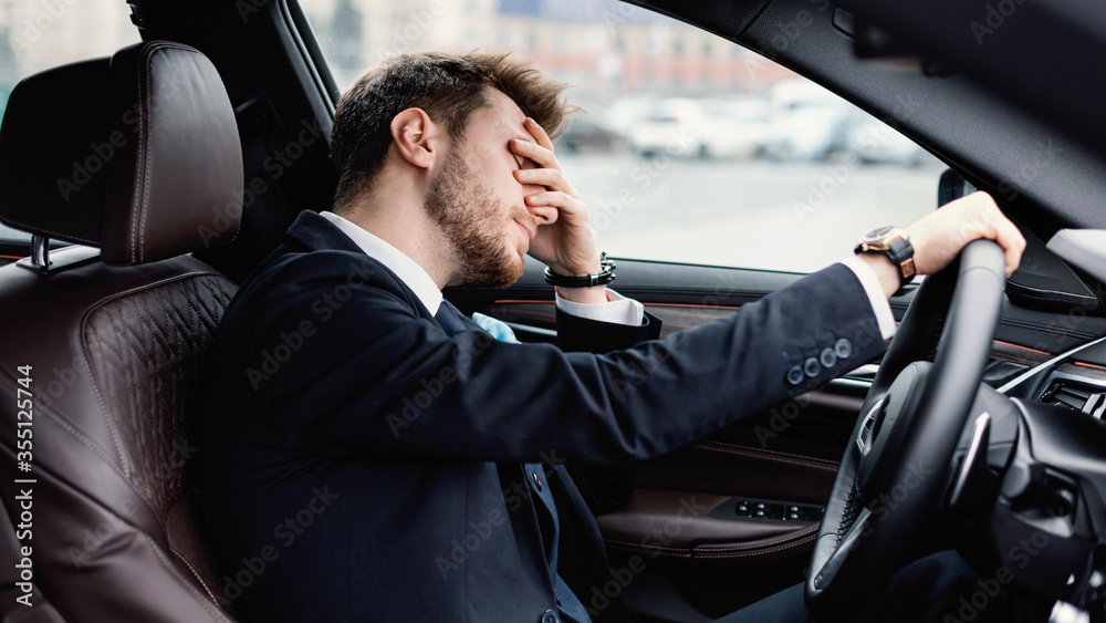 Sad young businessman driving alone in his new car Stock Photo | Adobe ...