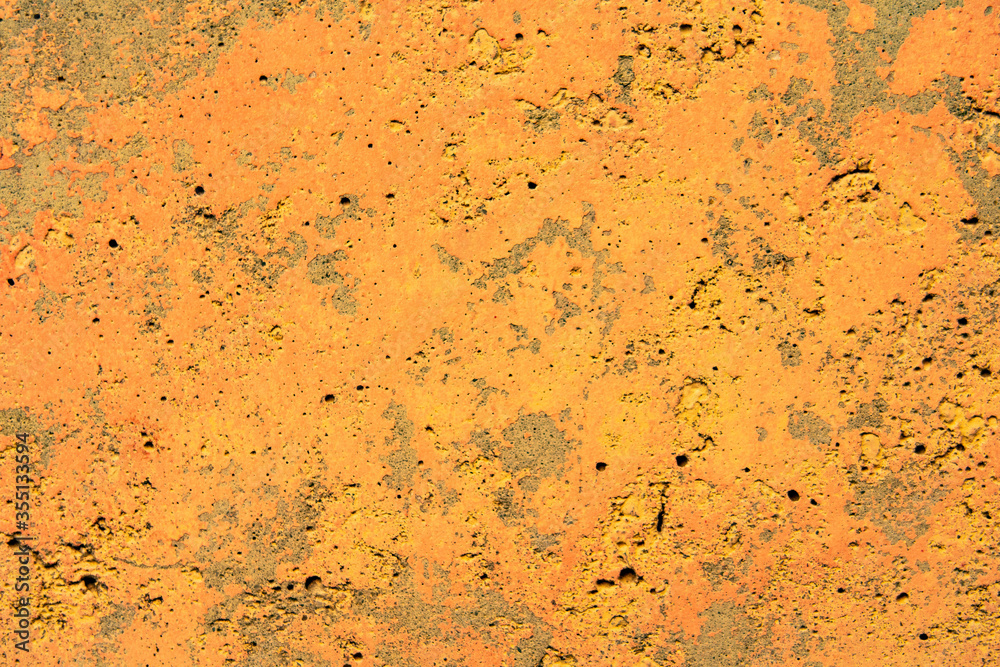 Flat surface of concrete slab with small holes and layers of old paint ...