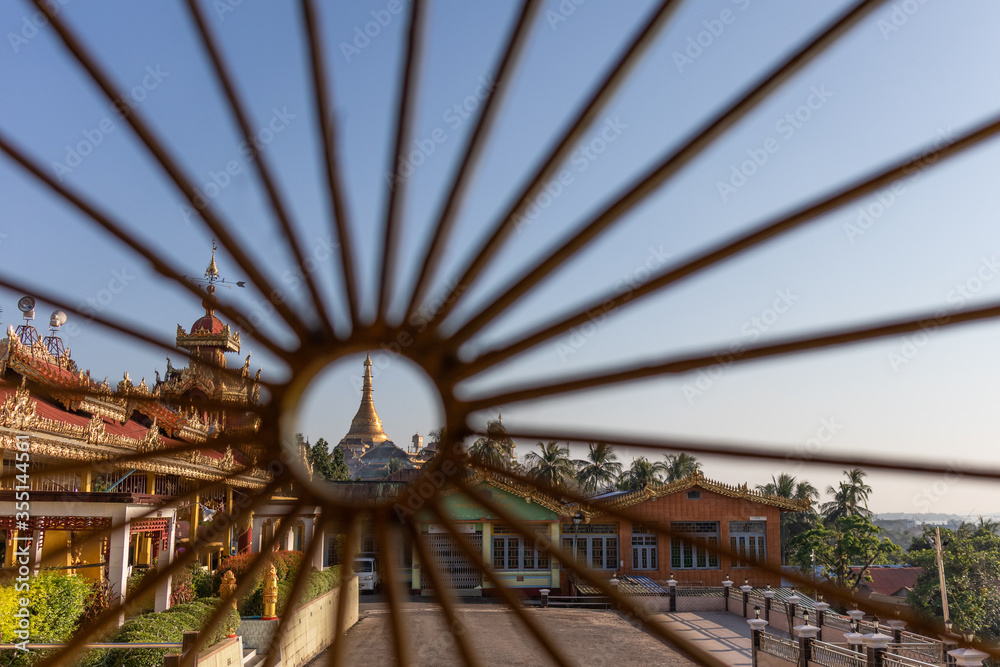Pagoda framed in a circle of a window, it looks like a sun framing the ...