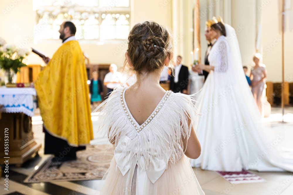 Little girl in a dress. She stands with her back. In the church. Stock ...