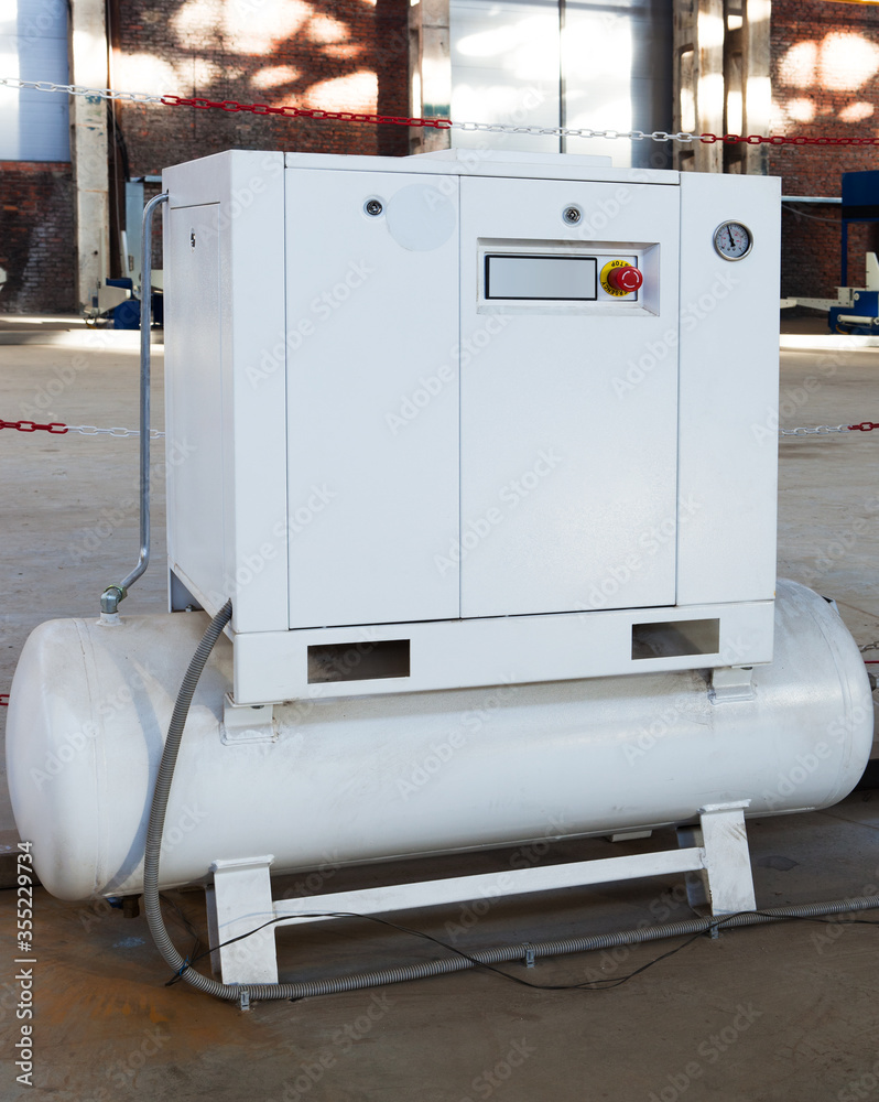 compressor with motor in a modern workshop Stock Photo | Adobe Stock